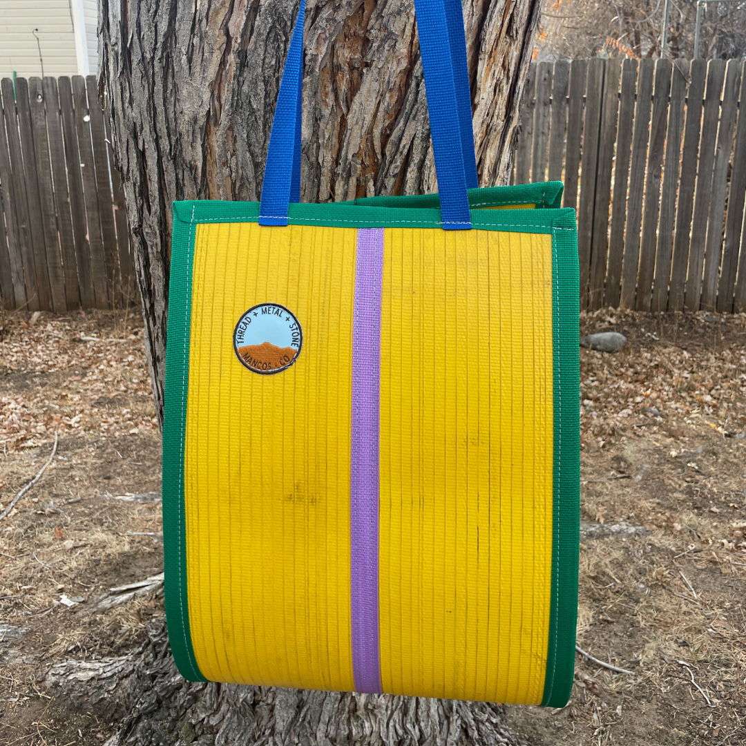 Repurposed Fire Hose Log Carrier – Thread + Metal + Stone
